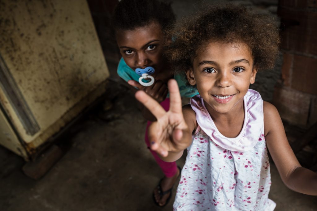 Brazilian little girl making two or V sign with her fingers - Educação ...